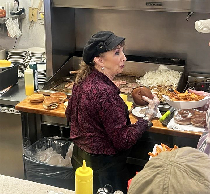 Decades of experience in those hands, flipping burgers with the precision of a surgeon and the flair of a concert pianist.