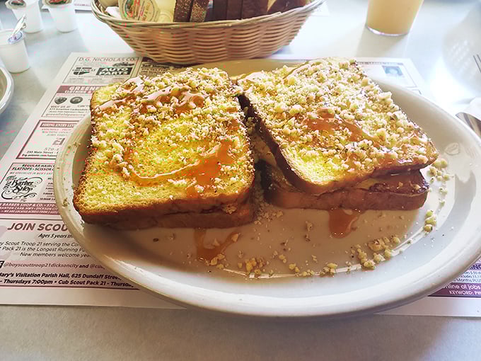 French toast transformed into a decadent sandwich, drizzled with syrup and dusted with crumbs&mdash;breakfast that thinks it's dessert, and we're not complaining.