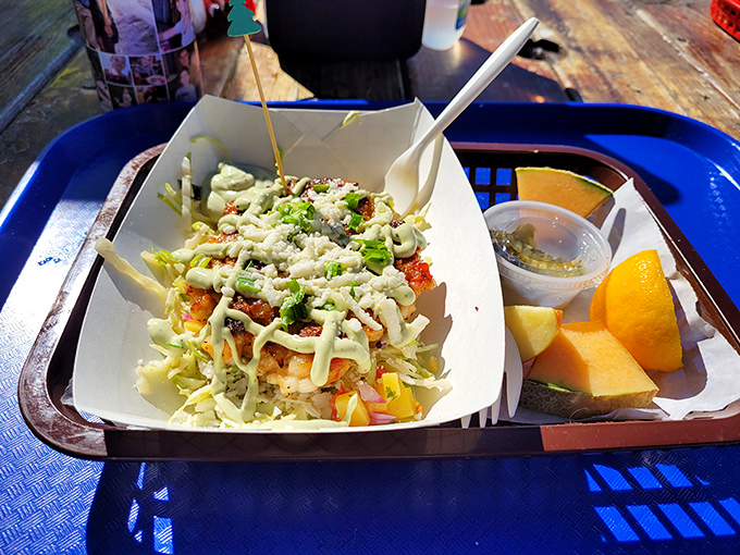 This isn't just a fish taco bowl; it's architecture, it's art, it's what happens when seafood finds its perfect home. The cantaloupe is there for moral support.