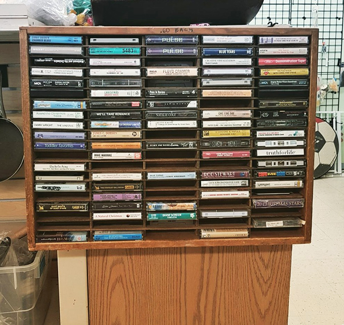 A time capsule of musical history organized in wooden slots. Each cassette represents someone's soundtrack to another era.