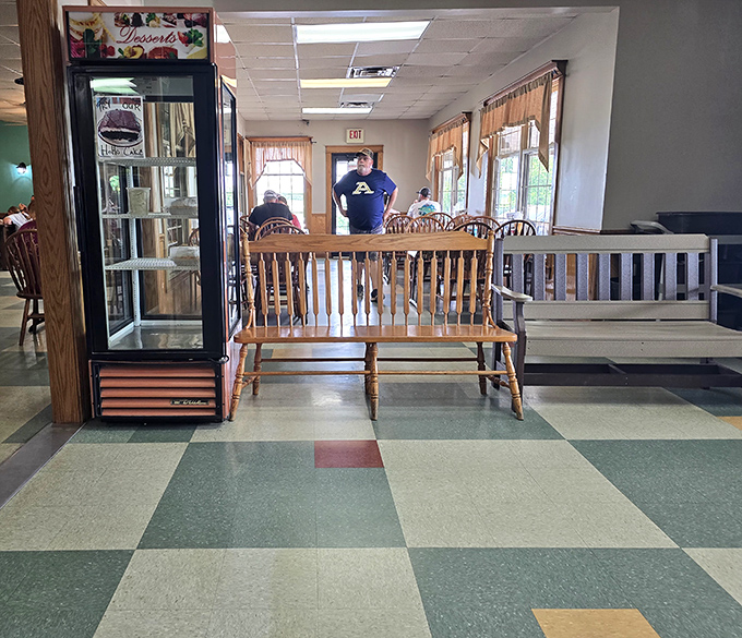 A wooden bench near the dessert case &ndash; either the best waiting area ever designed or the cruelest form of sweet temptation.