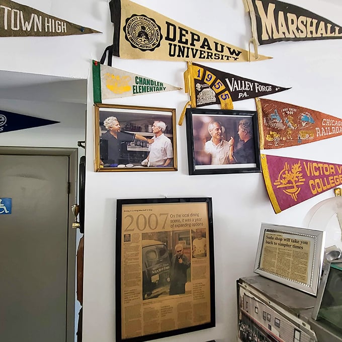 College pennants and newspaper clippings tell stories of community connections. This isn't just decoration&mdash;it's a scrapbook on the wall.