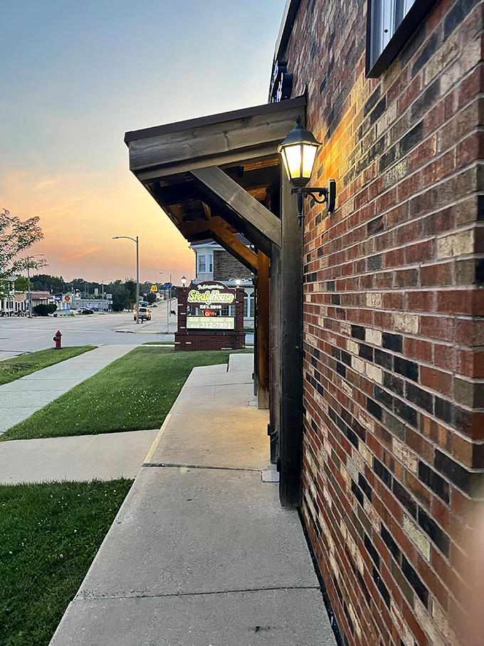 As dusk settles, the warm glow from Milwaukee Steakhouse beckons hungry travelers like a lighthouse for the famished.