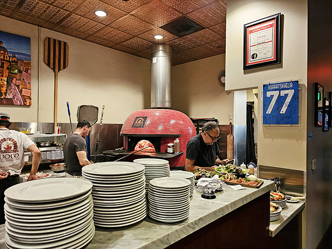 Pizza-making as performance art. The wood-fired oven reaches 900 degrees, cooking each pie to perfection in just 90 seconds.