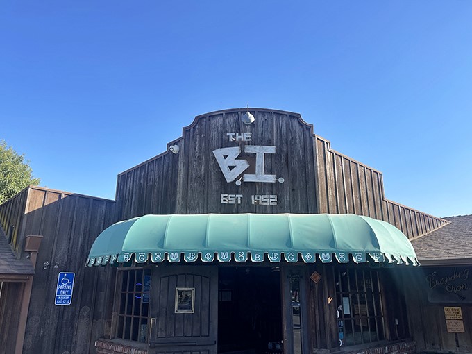 The Branding Iron stands proud against California skies—a wooden monument to the art of serious beef preparation.
