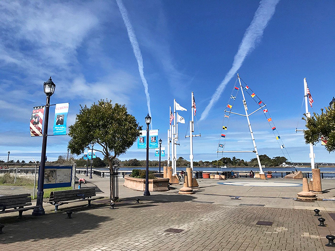 Eureka: Colorful flags flutter in the harbor breeze, marking this working port where fishing traditions continue alongside modern pleasures.