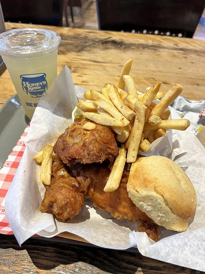 The holy trinity of comfort food: golden chicken, hand-cut fries, and a biscuit that could make a Southerner homesick.