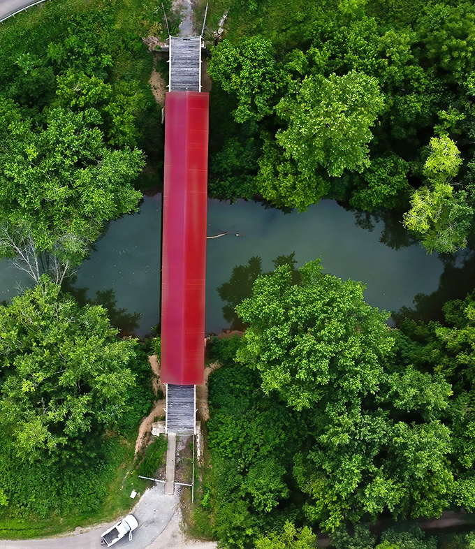 The bird's-eye view reveals how perfectly this human creation nestles into nature's embrace&mdash;a crimson brushstroke across a canvas of green.