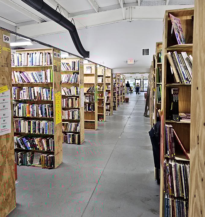 Wide aisles and wooden shelves create a warehouse aesthetic that puts the focus where it belongs: on the books themselves.