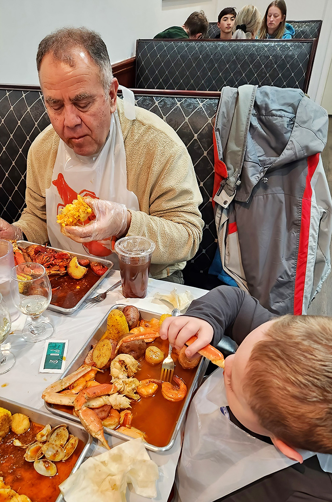 The universal language of seafood brings generations together. Plastic gloves, bibs, and focused expressions&mdash;the uniform and demeanor of serious seafood enthusiasts.