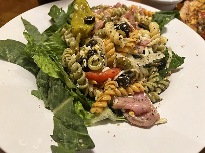 Tri-colored pasta salad with all the Mediterranean fixings&mdash;proof that "salad" doesn't have to be a four-letter word in the culinary sense.