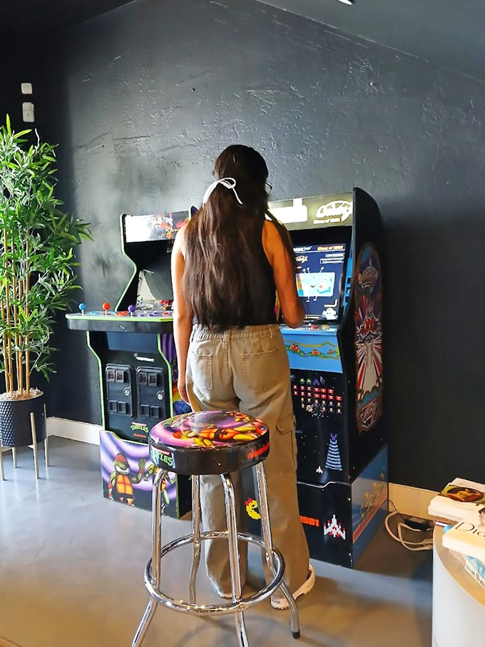 Gaming nostalgia tucked into a stylish corner. This arcade machine offers a moment of 8-bit joy between vintage clothing discoveries.