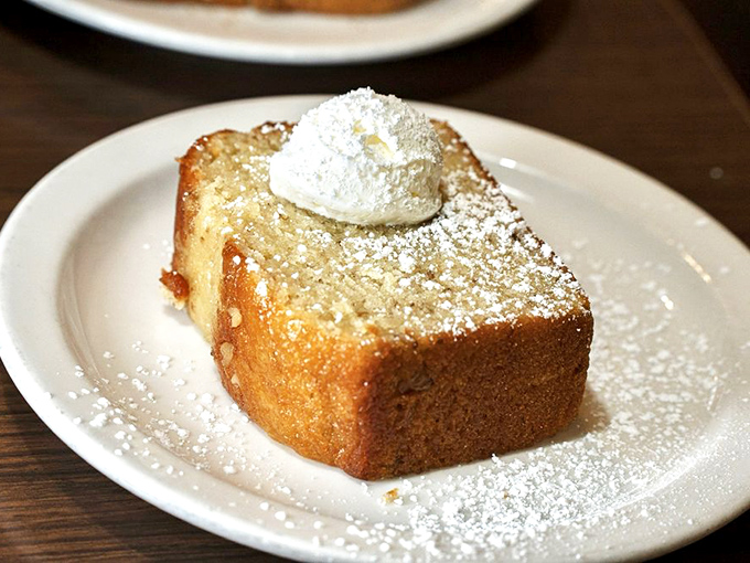 This banana bread isn't just baked, it's blessed&mdash;a golden slice of heaven topped with powdered sugar snow and whipped cream clouds.
