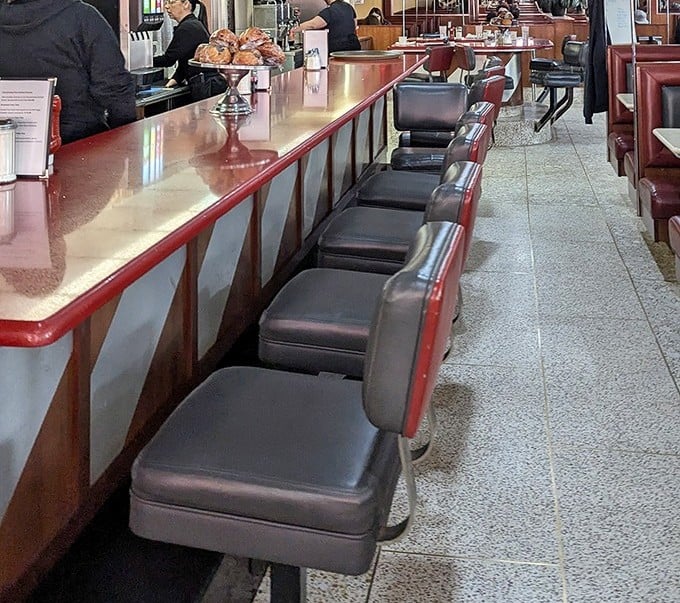 Counter seating: where regulars become family and servers remember your order before you sit down. Diner diplomacy happens one stool at a time.