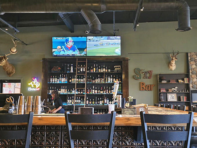 A bar stocked for serious business, with TVs strategically placed so you never miss a play while waiting for your burger.