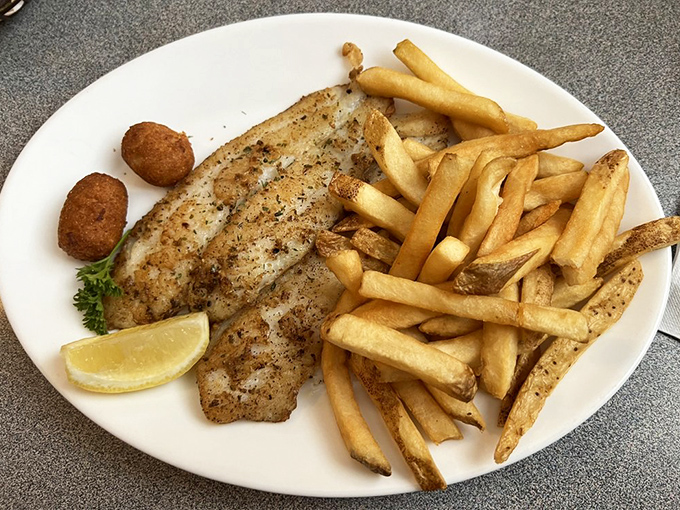 Perfectly grilled fish with golden fries and hush puppies&mdash;the holy trinity of Southern seafood dining that makes diets weep with jealousy.