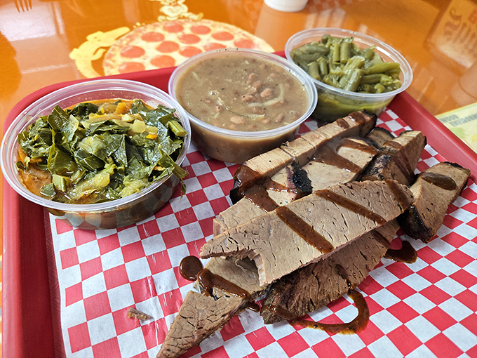 Meat and three, Texas-style! Perfectly sliced brisket with its telltale smoke ring shares the spotlight with collards, beans, and pure satisfaction.
