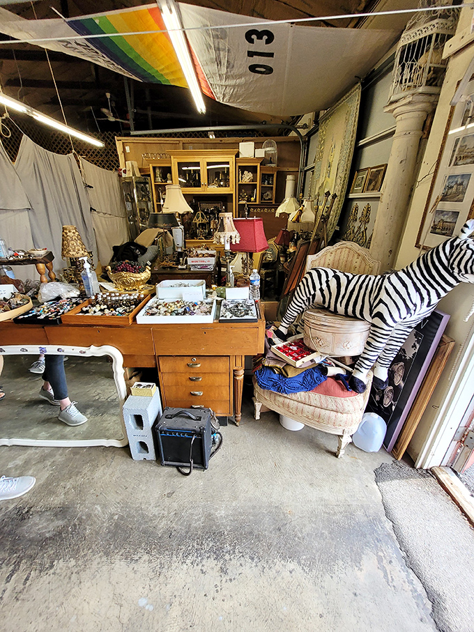 Organized chaos at its finest! This vendor's booth showcases the eclectic heart of flea marketing, where zebra figurines neighbor vintage jewelry displays.