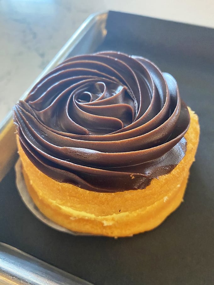 This chocolate-topped delight isn't just dessert&mdash;it's architecture. The precision of that frosting swirl would make Frank Lloyd Wright jealous.