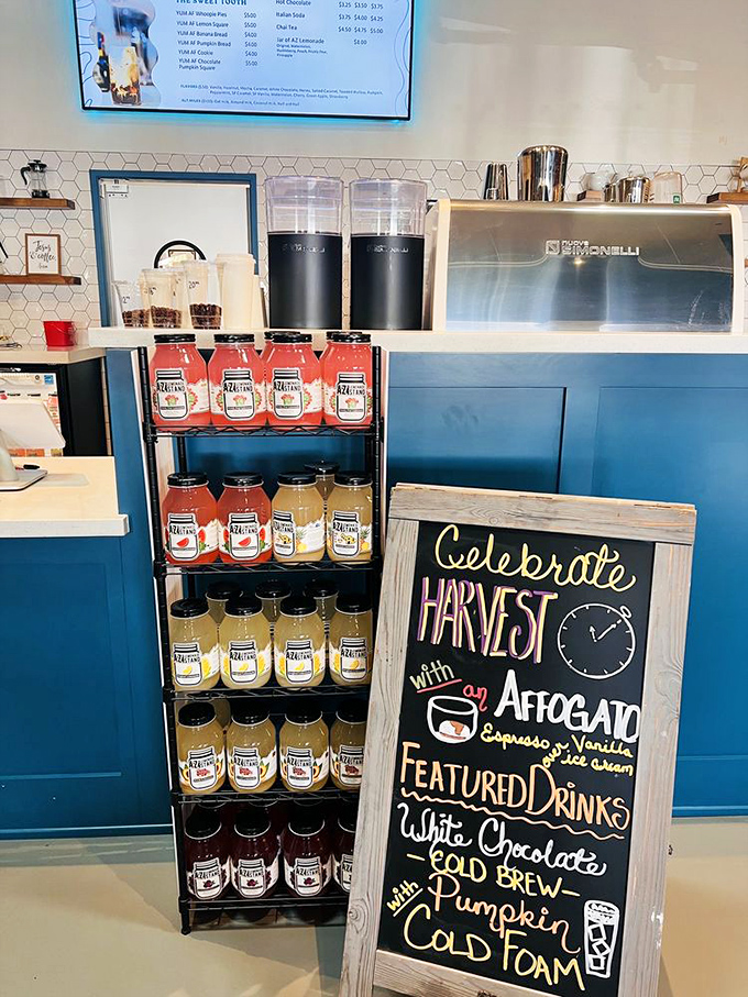 Mason jars filled with colorful refreshments line up like soldiers, while a chalkboard menu promises seasonal delights for the caffeine-inclined.