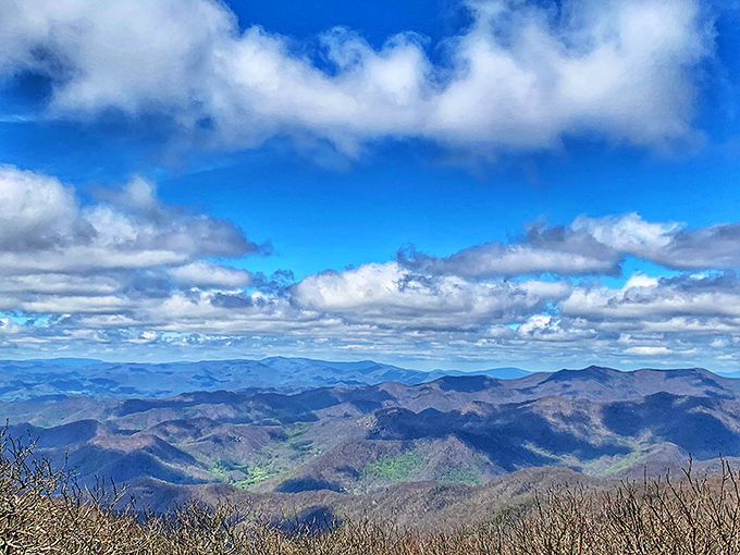 The ever-changing sky creates a different masterpiece every hour, with clouds painting shadows across the ancient peaks below.