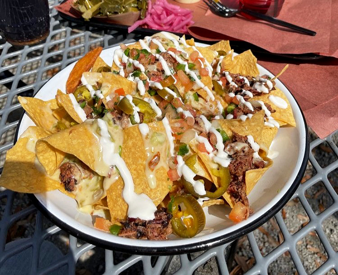 Nachos that refuse to be ordinary. Each chip stands proud as a delivery system for smoky meat, melty cheese, and that drizzle of pure joy.