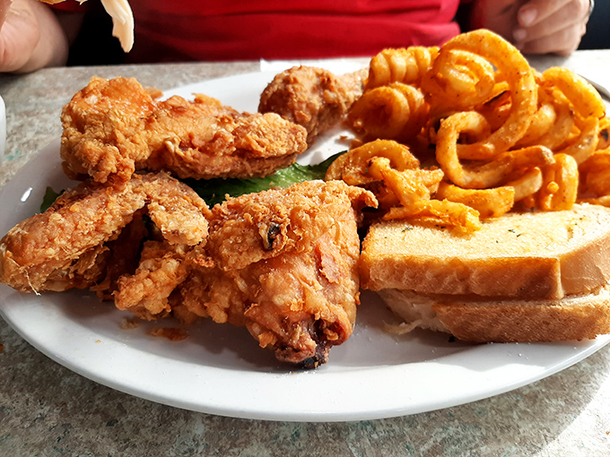 Golden-fried chicken that crackles with each bite, paired with curly fries that twist and turn like the plot of a good mystery novel.