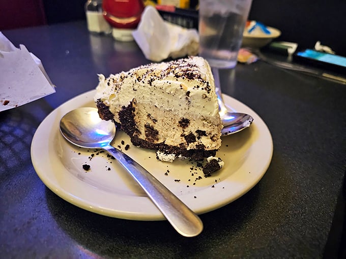 A slice of chocolate cream pie that makes you question why you ever waste calories on lesser desserts. The crumbled cookie crust is just showing off.