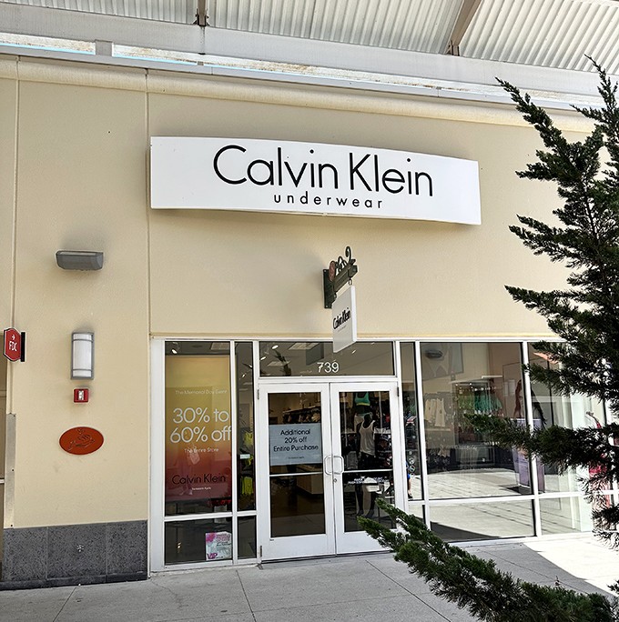 Calvin Klein's clean, modern storefront promises understated elegance at outlet prices. Those iconic undergarments and basics await your discovery.