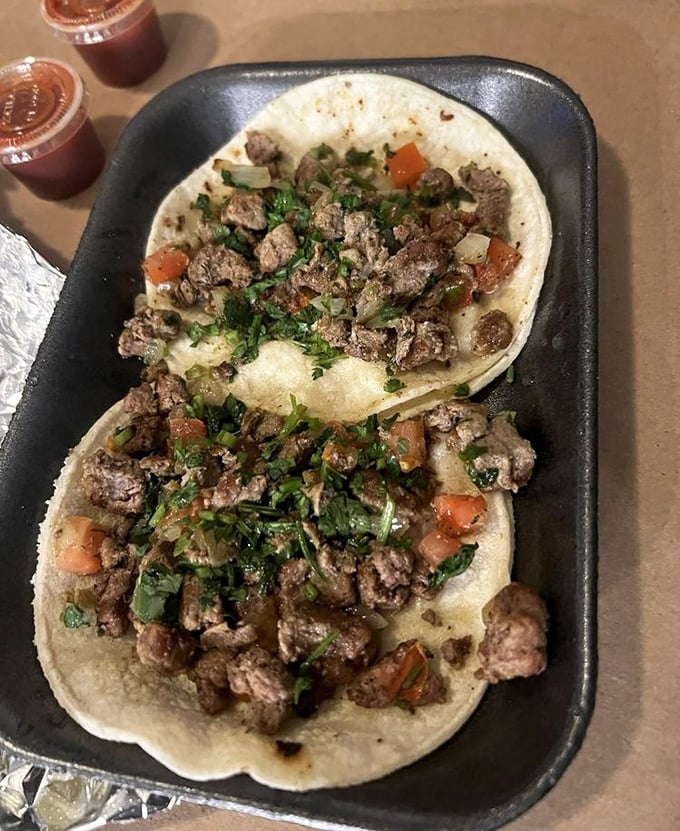 Carne asada tacos topped with fresh cilantro and onions &ndash; simplicity elevated to pure art form. 