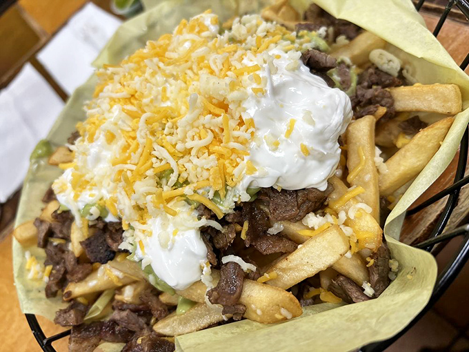 Carne asada fries—San Diego's gift to the world—where French fries bravely volunteer to support the weight of meat, cheese, sour cream, and your expectations.