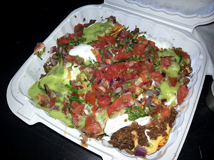 Carne asada nachos topped with guacamole, sour cream, and pico de gallo represent comfort food at its finest. 