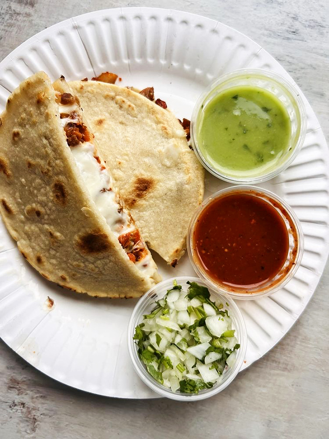 The carnitas mulita, where cheese meets tortilla meets pork in a sandwich-taco hybrid that defies categorization but embraces deliciousness.
