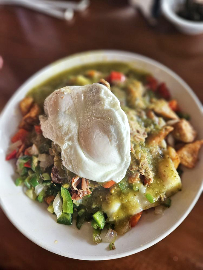 The carnitas skillet arrives like a breakfast rebellion&mdash;traditional morning ingredients mingling with Mexican flavors under a perfectly poached egg crown.