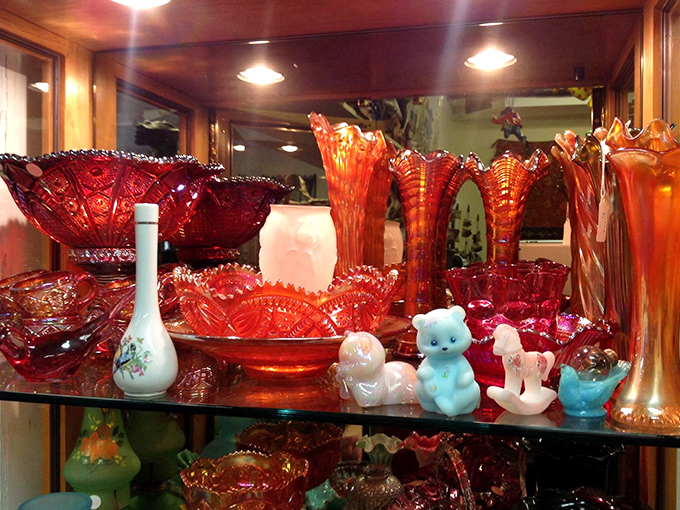 Carnival glass in fiery oranges and reds, with whimsical figurines playing hide-and-seek among the iridescent treasures.