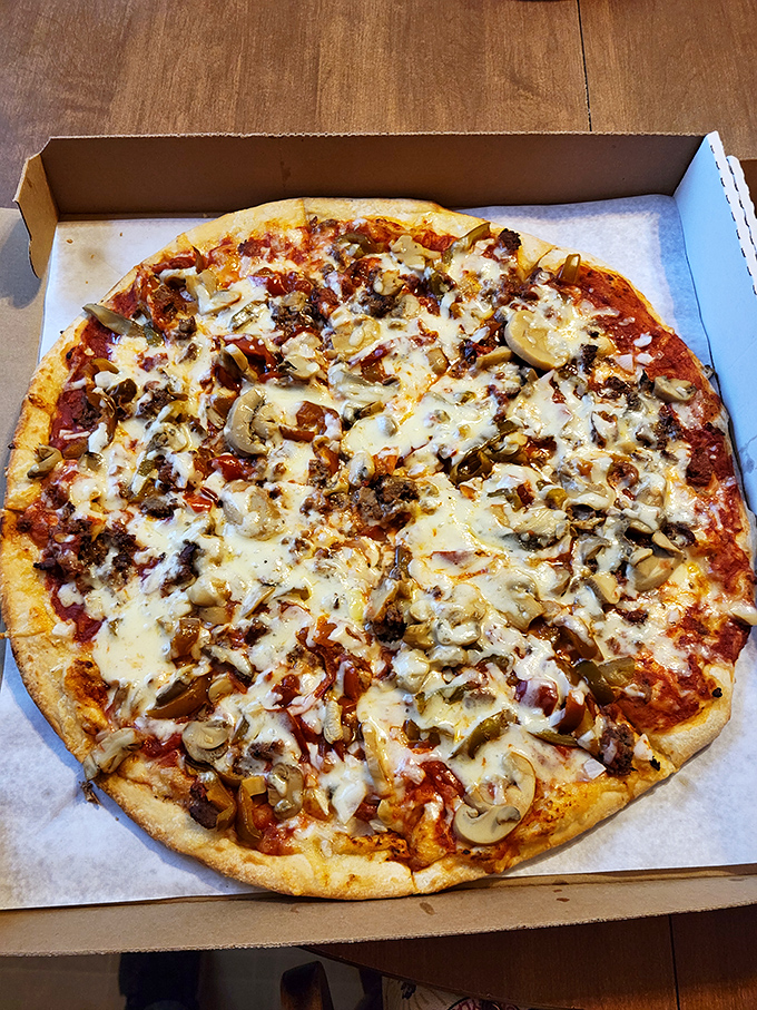 A loaded pizza that doesn't just satisfy hunger—it obliterates it with a perfect storm of cheese, meat, and mushrooms.