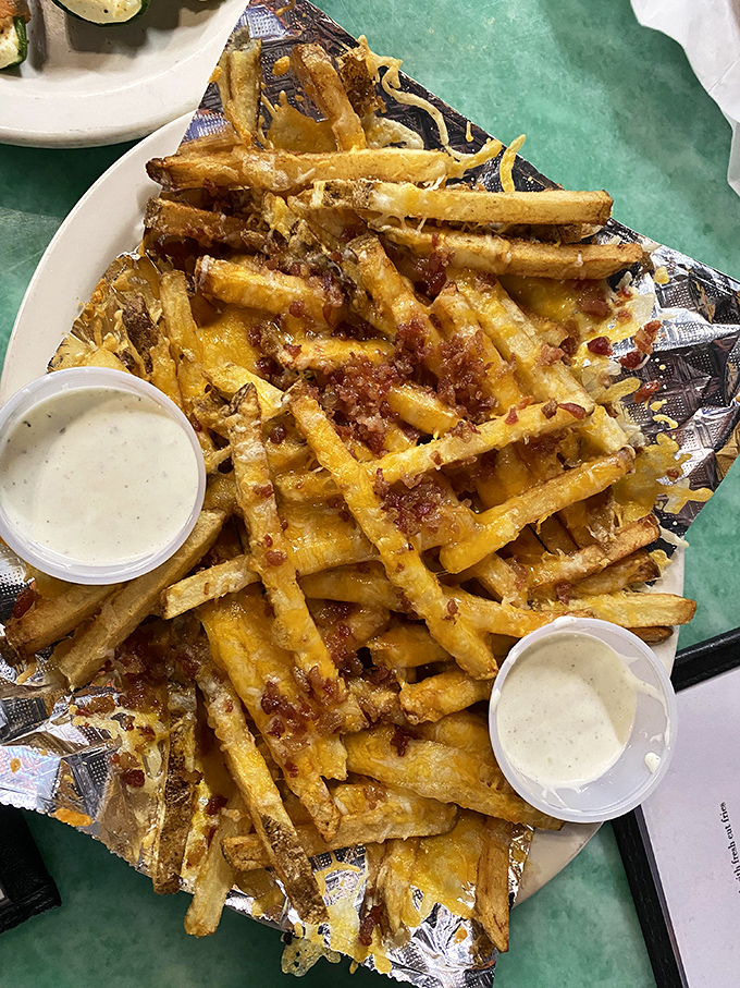 These loaded fries aren't just a side dish&mdash;they're a main event. Cheese, bacon, and those two dipping sauces are staging a flavor intervention.