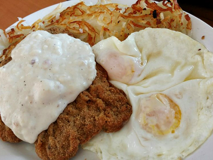 Country fried steak with gravy alongside sunny-side-up eggs creates the perfect breakfast trinity&mdash;crispy, creamy, and runny in harmonious balance.