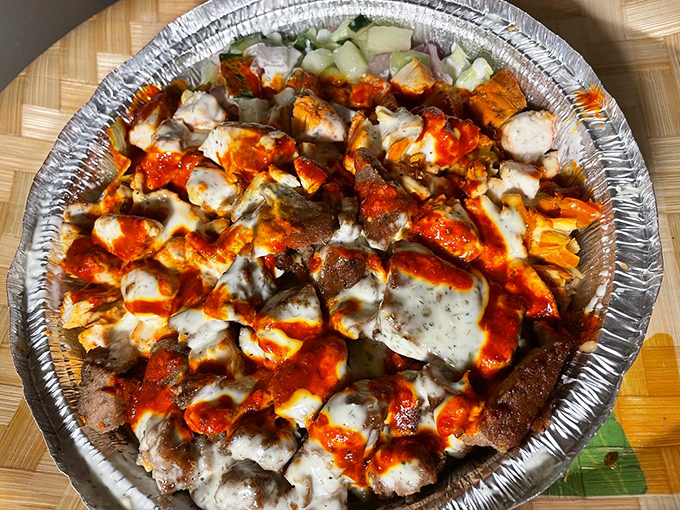 A mountain of saucy protein that laughs in the face of moderation. This combo platter is what food dreams are made of.