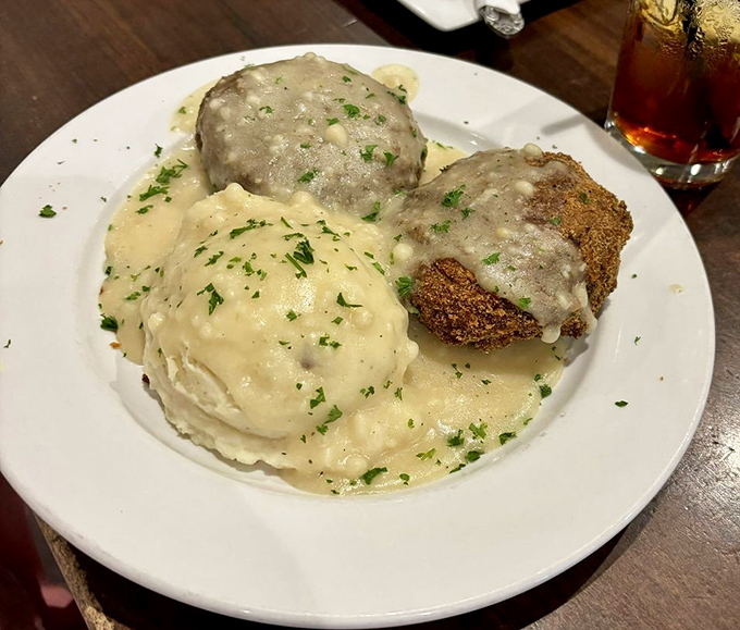 Golden-brown chicken croquettes bathed in velvety gravy alongside cloud-like mashed potatoes&mdash;comfort food that hugs you from the inside.