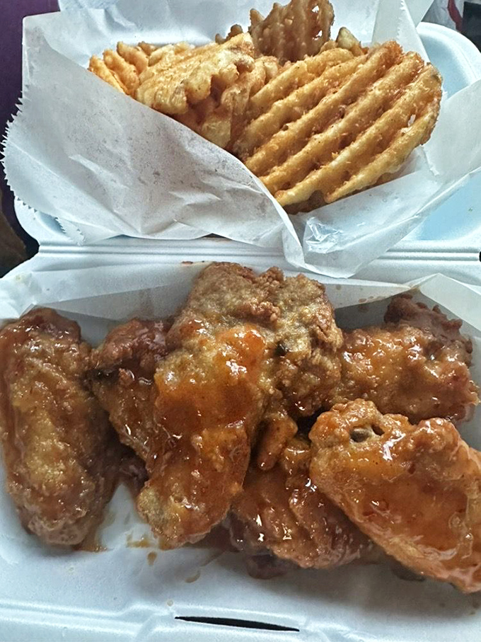 Wings and waffle fries that prove side dishes aren't afterthoughts. That sticky-sweet sauce demands both napkins and respect.