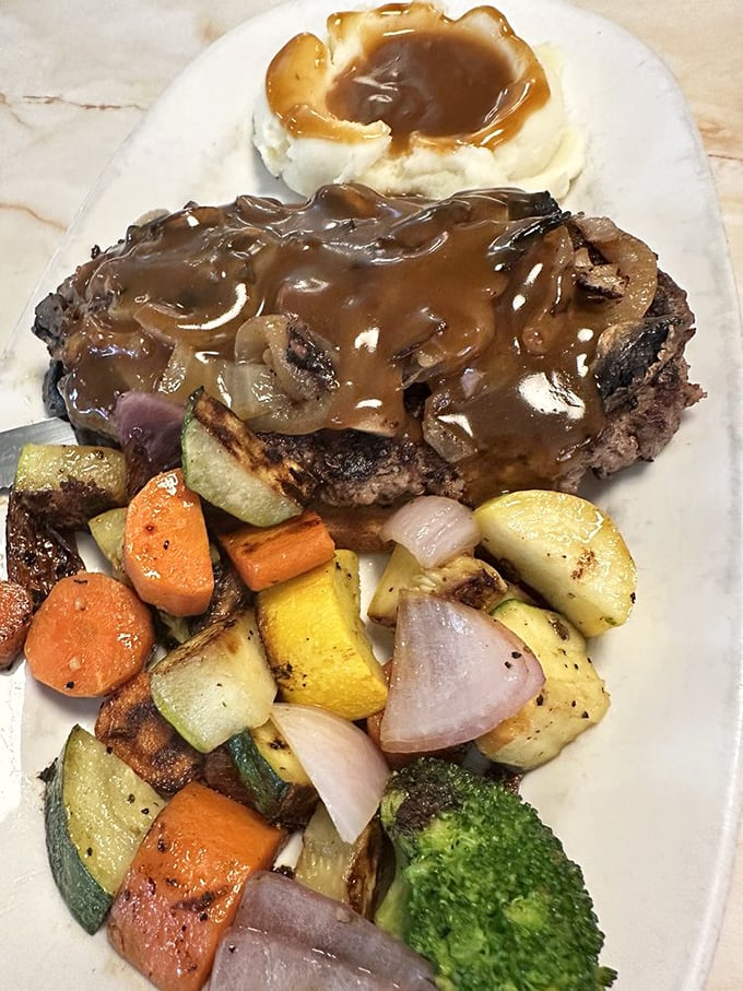 Chopped steak smothered in mushroom gravy&mdash;comfort food that speaks a universal language. Those roasted vegetables aren't just healthy&mdash;they're absolution for the gravy. 