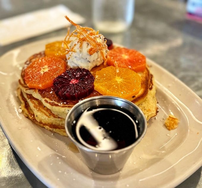 Pancakes wearing citrus wheels like edible jewelry. These flapjacks dress better for breakfast than most people do for dinner parties.