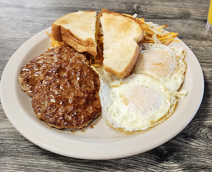 The breakfast trifecta: eggs, sausage, and toast done exactly how your grandmother would approve.