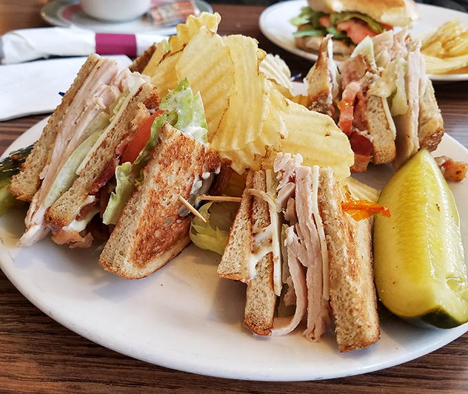 The architectural marvel that is a proper club sandwich—layers of deliciousness held together by the humble toothpick, civilization's unsung hero.