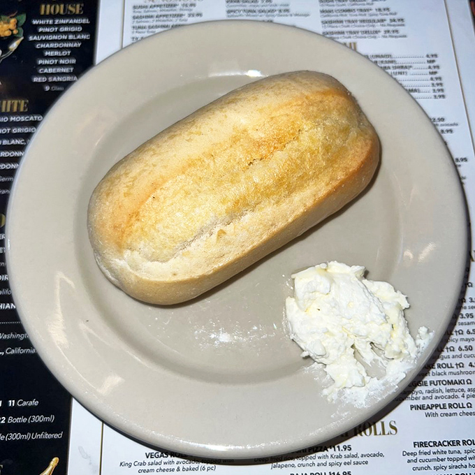 The bread arrives warm and pillowy, with a side of butter that's already melting. The meal hasn't started, but happiness has.