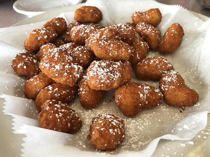 Corn nuggets dusted with powdered sugar&mdash;Florida's answer to donut holes. These golden puffs of joy are what happiness would look like if it were fried.