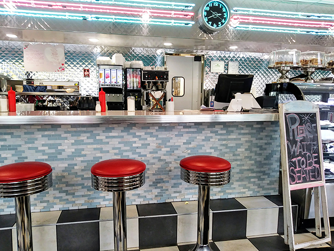 Those red counter stools have heard more local news, personal triumphs, and neighborhood gossip than any social media platform could ever hope to capture.