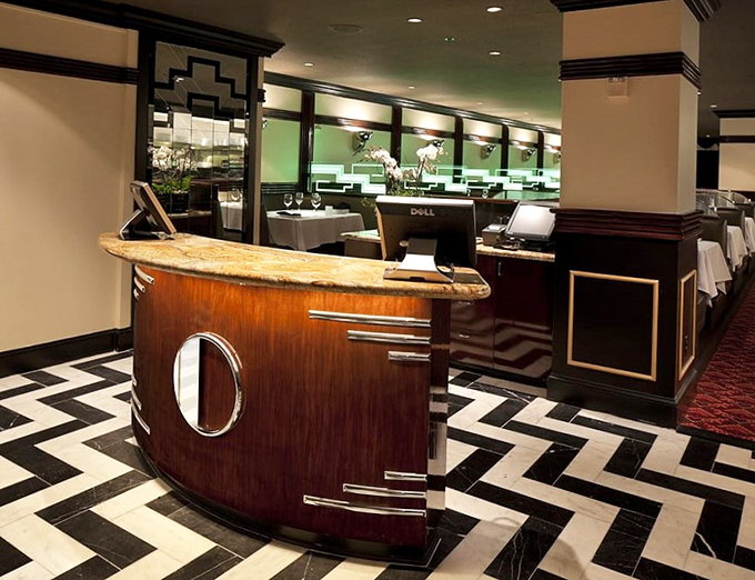 Art Deco meets modern luxury at Osso's reception desk, where the striking black and white chevron floor announces this isn't your average steakhouse.