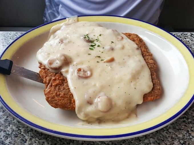 Country fried steak swimming in peppery gravy—the dish your doctor warned you about but your grandmother would absolutely approve of.
